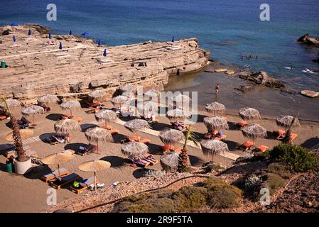 Top view of a rocky coastline with an equipped beach,sun loungers and ...