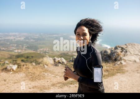 Morning run and workout. Happy african american girl in sportswear and ...