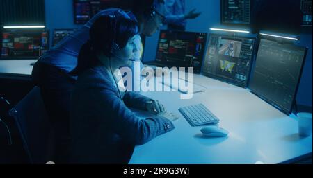 Multiracial flight control operators monitor space mission on multi ...
