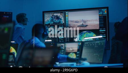 Flight control operators monitor space mission on computers in command ...