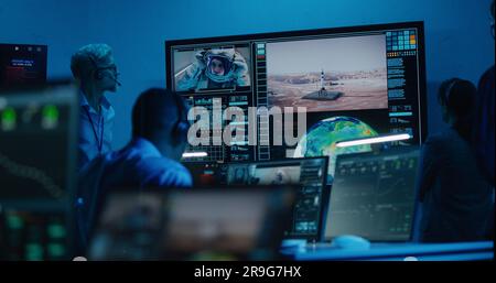 Flight control operators monitor space mission on computers in command ...