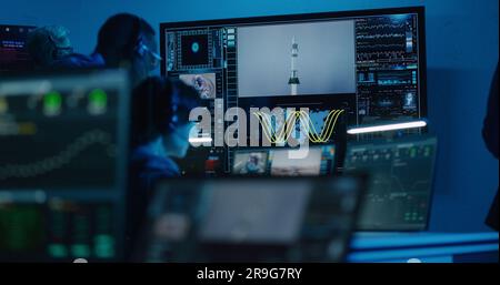 Flight control operators monitor space mission on computers in command ...