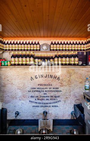 Ginjinha sour cherry liqueur bottles on shelf, inside A Ginginha Bar ...