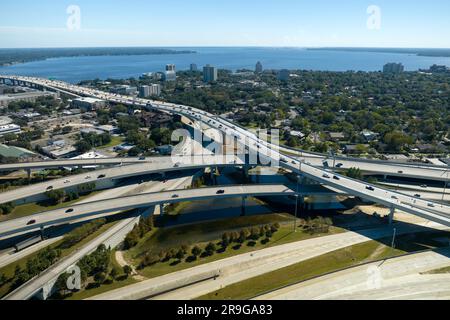American freeway intersection with fast driving cars and trucks. View ...