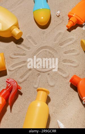 Creative composition with different sunscreen creams and flip flops on ...