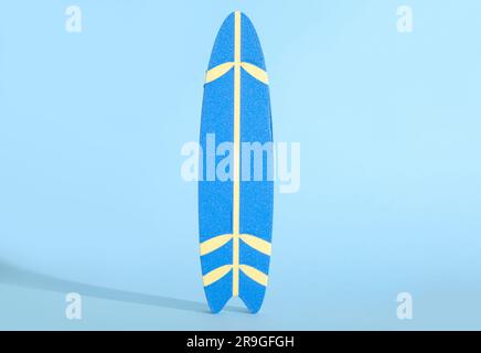 Mini surfboard on blue background Stock Photo - Alamy