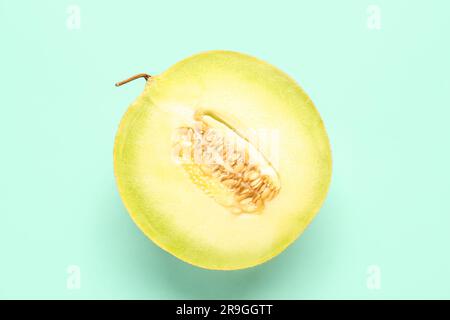 Half of sweet melon on turquoise background Stock Photo - Alamy
