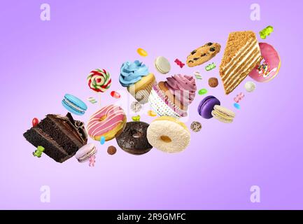 Many delicious sweets falling on white background Stock Photo - Alamy