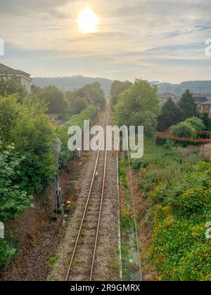 A vertical shot of railway tracks at sunset Stock Photo - Alamy