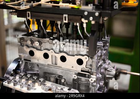 Process of screwing threaded studs into cylinder block case Stock Photo ...