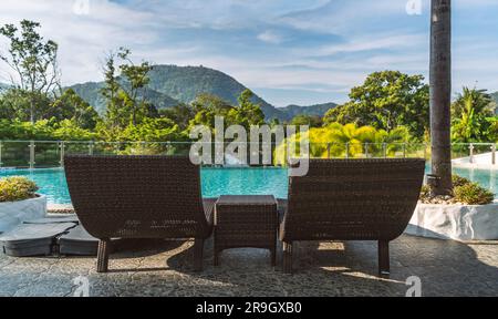 Swimming pool with two desk chairs over clear blue sky Stock Photo - Alamy