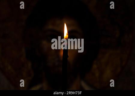 burning candle illuminates the icon of Jesus Christ Stock Photo - Alamy