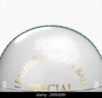 A regular white cricket ball with green stitching on an isolated ...