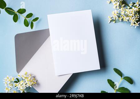 Envelope with blank card and eucalyptus on color background Stock Photo ...