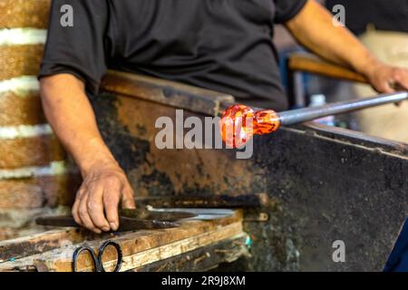 Glass in fusing temperature blowing to make a bottle with the old ...