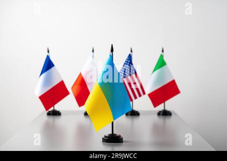 Small country flags standing at a table Stock Photo - Alamy