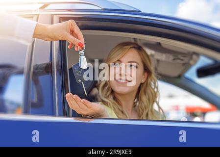 A woman's hand passes the key to the car Stock Photo - Alamy