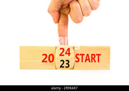 2024 restart new year symbol. Businessman turns a wooden cube and ...