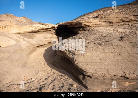 Ventifact rock formations caused by wind at La Pared Beach ...