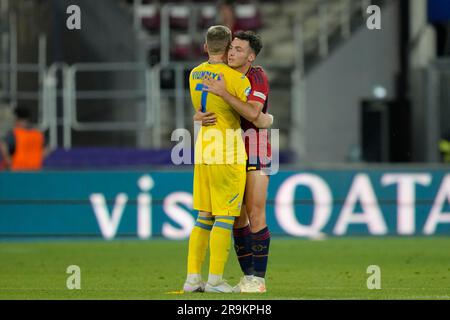 Ukraine's Bohdan Viunnyk hugs Arnau Martinez of Spain at the end of the Euro 2023 U21 ...