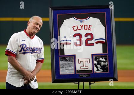 Former Major League pitcher David Clyde, right, hands the ball to ...