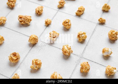 Tasty popcorn on white tile background Stock Photo - Alamy
