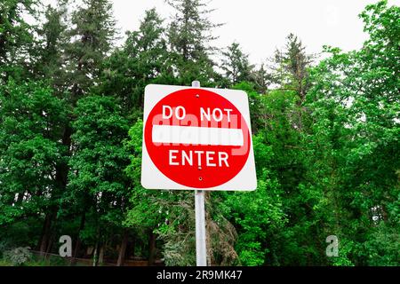 Vivid Red Do Not Enter Road Sign Against the Lush Green Forest ...