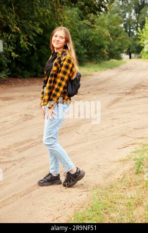 Outdoor fashion portrait of cute preteen gid girl wearing bright red ...