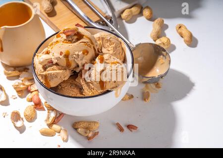 Peanut butter ice cream balls. A lot nuts gelato scoops in ceramic bowl ...