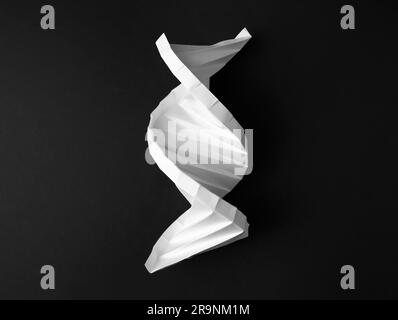 Paper model of DNA molecular chain on black background, top view. Space ...
