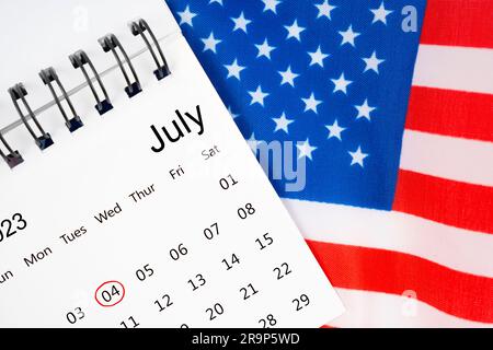 4 th July calendar with part of an American flag on white background ...