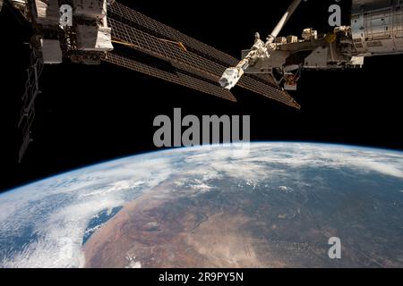 A portion of the International Space Station's solar arrays drape the ...