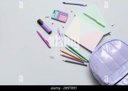 Notebooks and pens on lilac background Stock Photo - Alamy