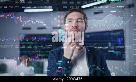 Male investment specialist analyzes cryptocurrency charts in modern ...