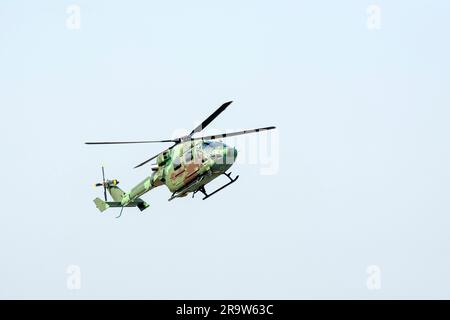 Close-up of flying chopper against isolated blue sky. Indian air force ...
