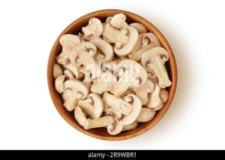 Close up of fresh sliced champignon mushrooms on rustic wooden cutting ...