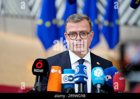 Finland's Prime Minister Petteri Orpo speaks with the media as he arrives for an EU summit at ...