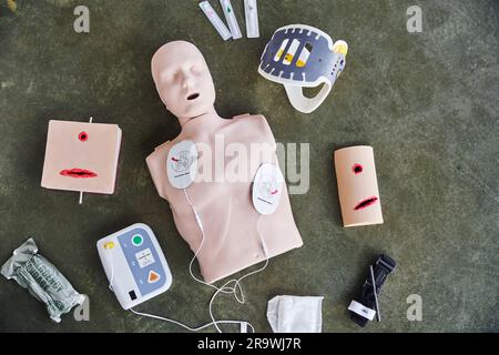 top view of CPR manikin, automated external defibrillator, wound care simulator, neck brace and ...