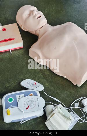 automated external defibrillator near wound care simulator, CPR manikin and neck brace on ...