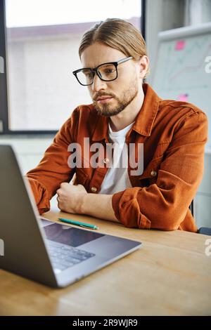 Successful young entrepreneur with attentive and concentrated look ...