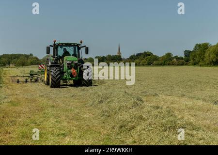 Turning grass for silage making with a John Deere 6130R tractor and a ...