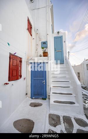 White Cycladic houses with colourful shutters and doors, alleys of the ...