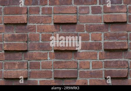 decorative red brick wall, running bond with protruding pairs of ...