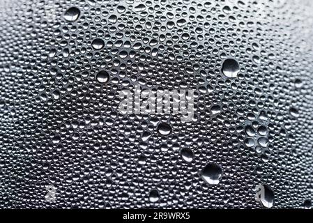 Many little water drops due to condensation on a plastic bottle curved ...