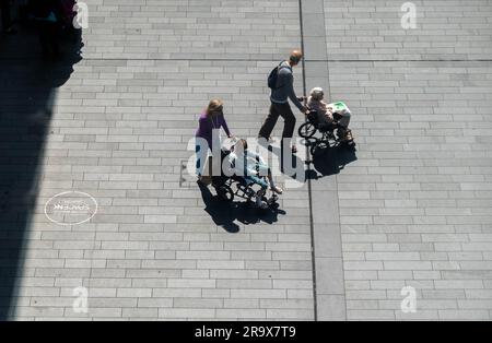 Two elderly people being pushed in wheelchairs in Liverpool One ...
