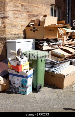 Cartons and stacks of waste paper, waste paper collection, green bin ...