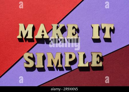 Keep it simple words on wooden blocks on dark gray background. Business ...