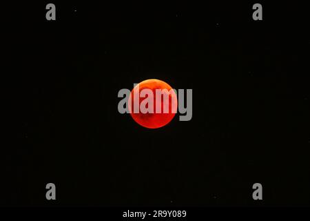 Details of full red moon over dark black sky by night. The total phase ...