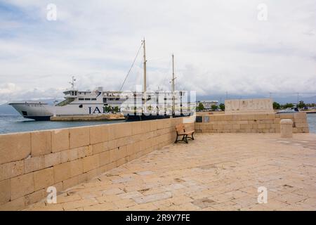 The harbour sign and ferry in Supetar port, Brac Island, Croatia. The ...