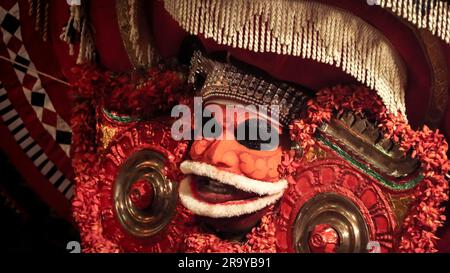 closeup of bright colored and decorated theyyam, a traditional artform ...